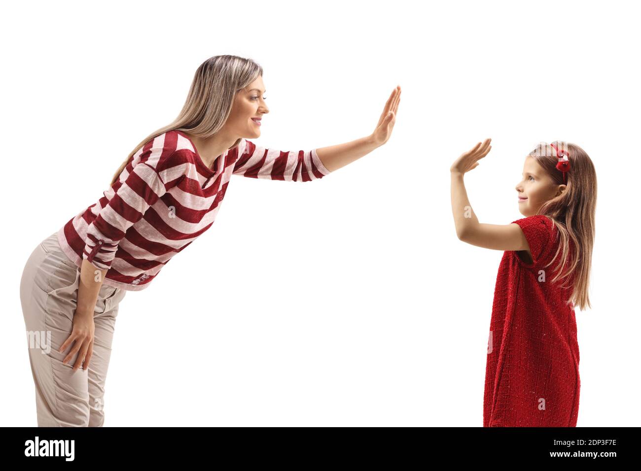 Woman making a high-five gesture with a girl in a red dress isolated on ...