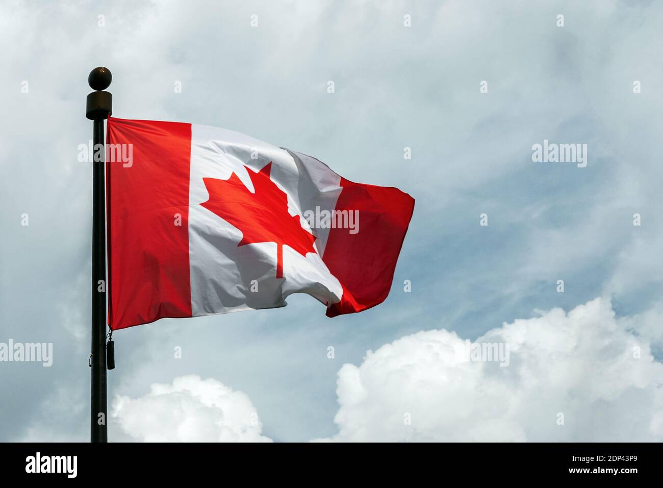 Flag of Canada on flagpole floating in the sky Stock Photo - Alamy