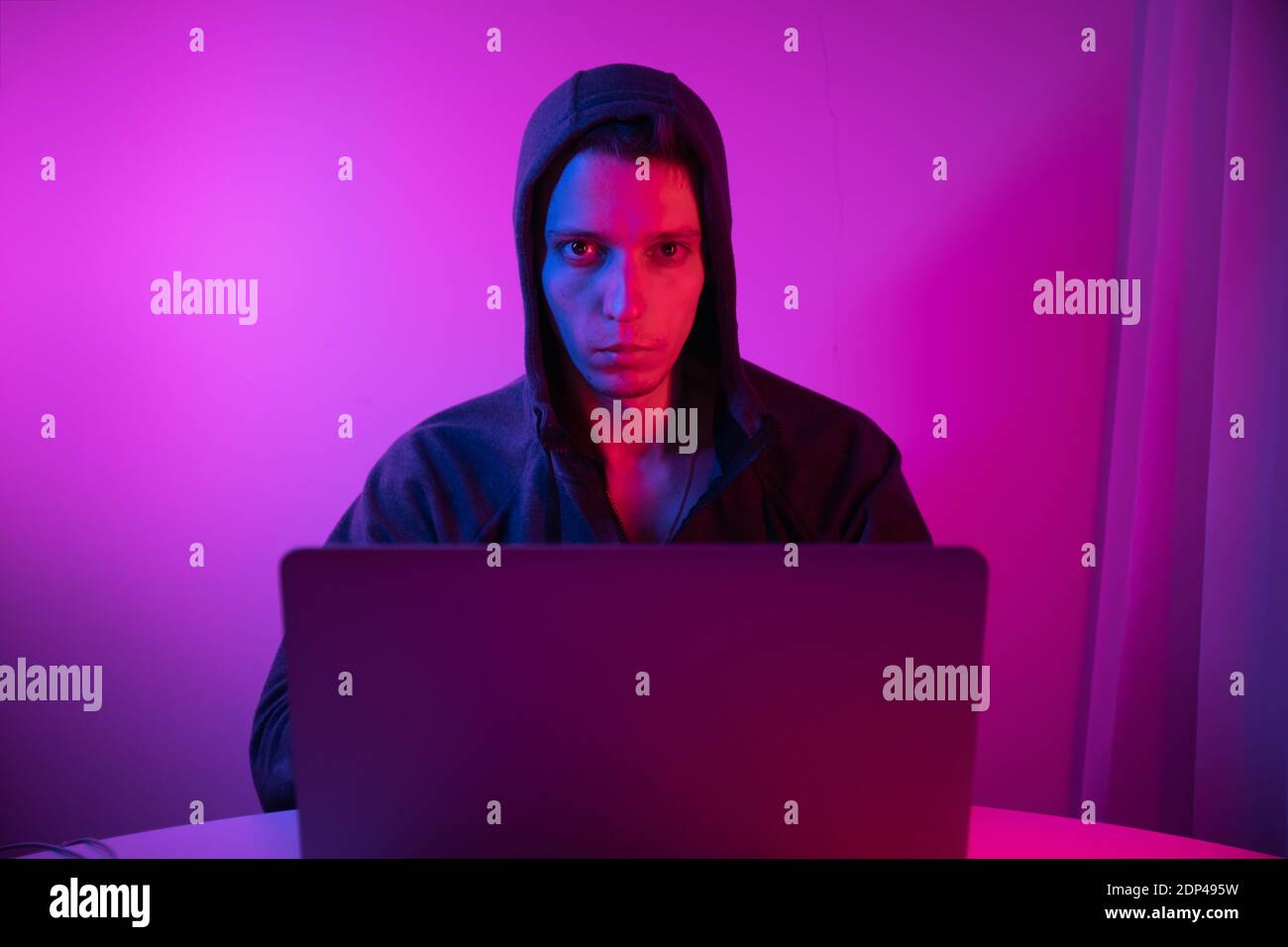 Gamer plays on a laptop. The programmer writes the code. Man on a ...