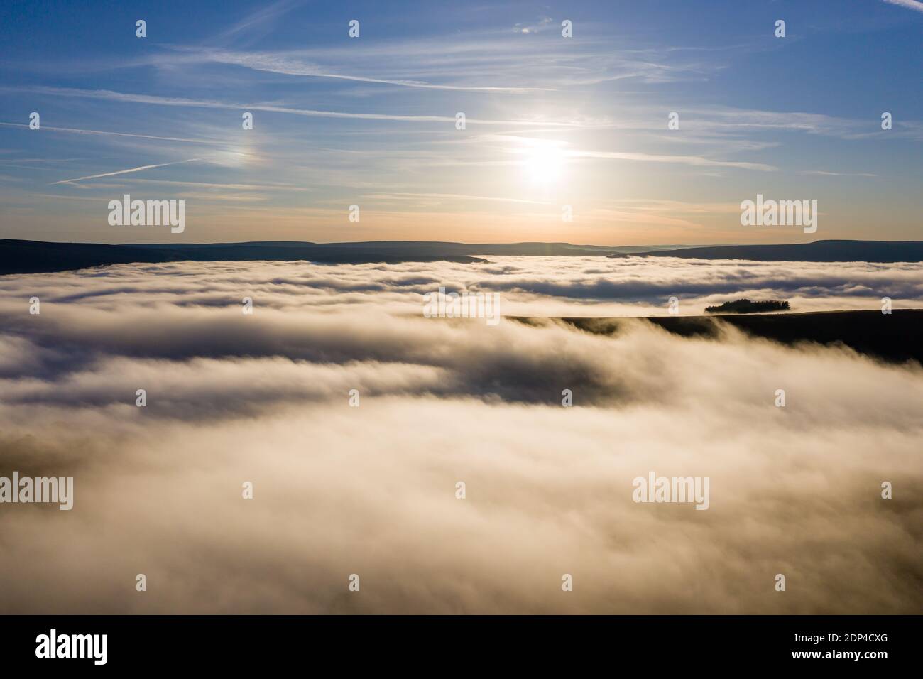 Aerial view of the sun setting above a sea of fog and low cloud Stock ...