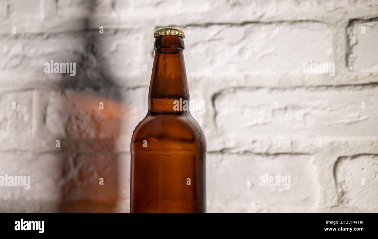Beer bottle without label on brick wall background Stock Photo - Alamy