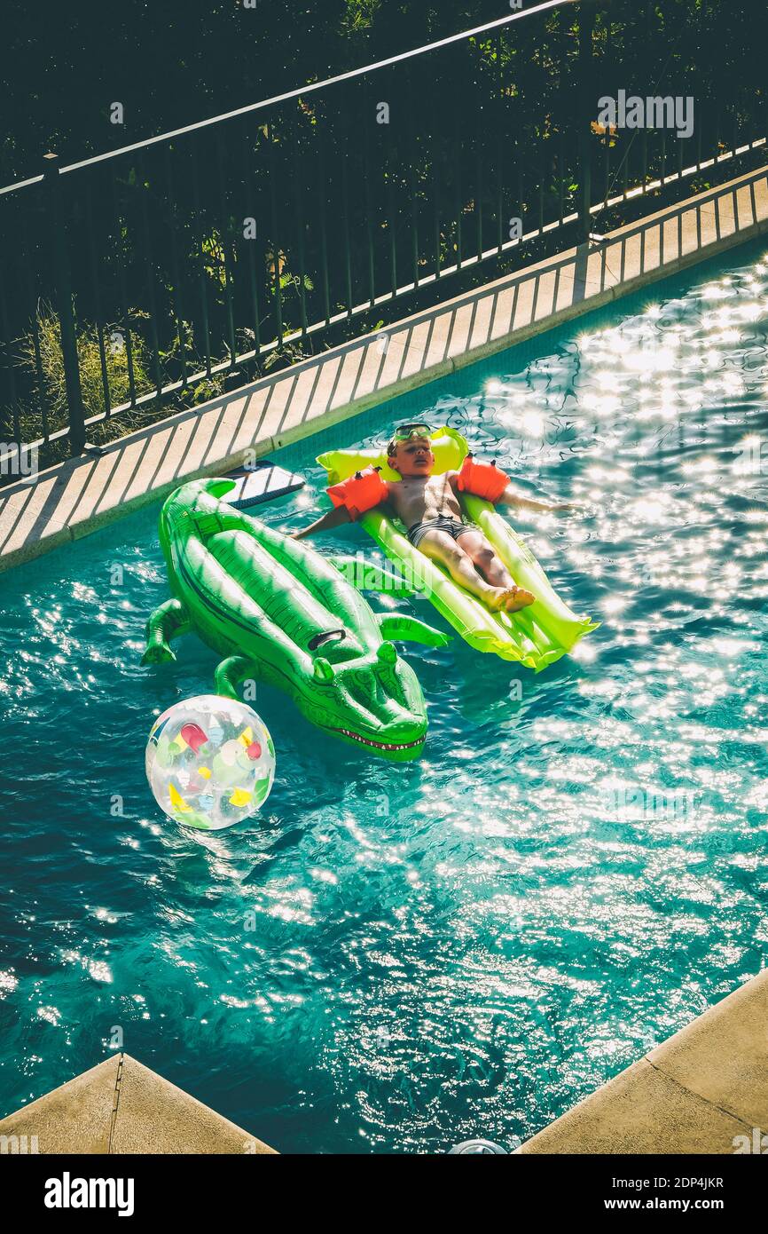 Young Boy on Float in Swimming Pool Stock Photo - Alamy