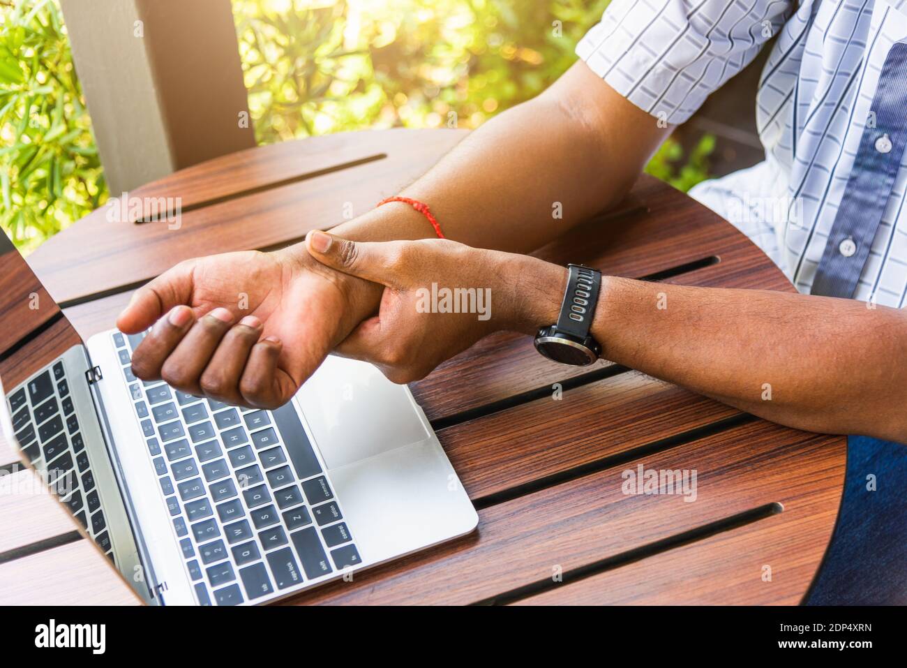 Closeup hands the Asian black man holding his wrist pain from using ...