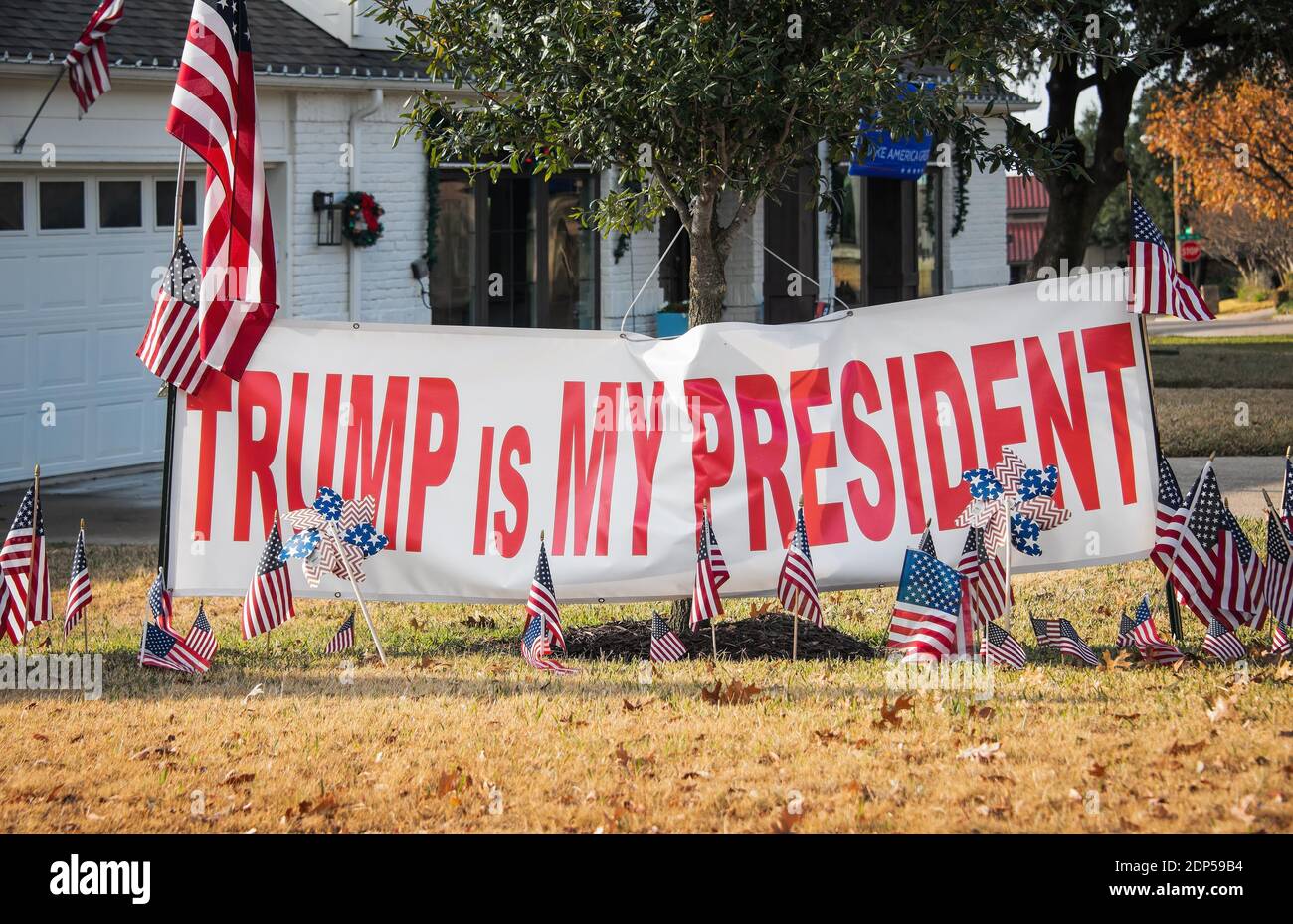 Texas, USA- December 11, 2020. Trump supporter sign and American flags ...