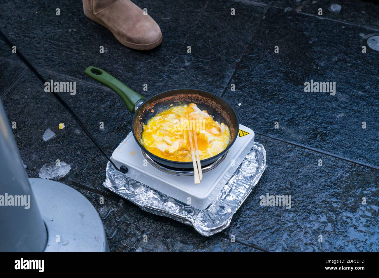 New York, NY - December 18, 2020: Homeless woman (not pictured) cooks ...