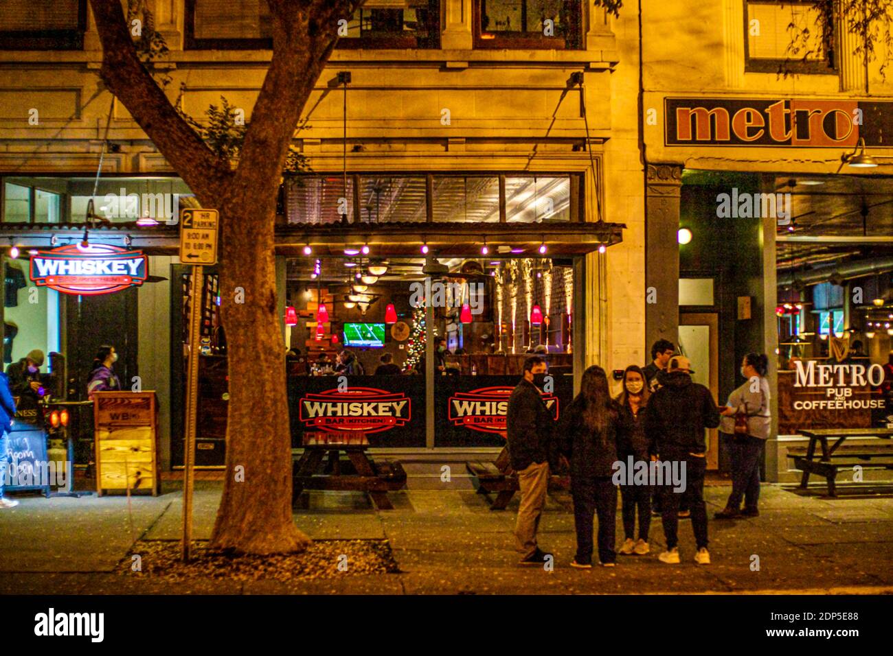 Augusta, Ga USA - 12 17 20: Groups of people downtown at night wearing ...
