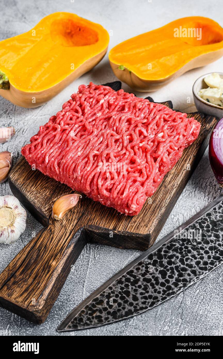 Raw mince meat, pumpkin with garlic and onion. White background. Top ...