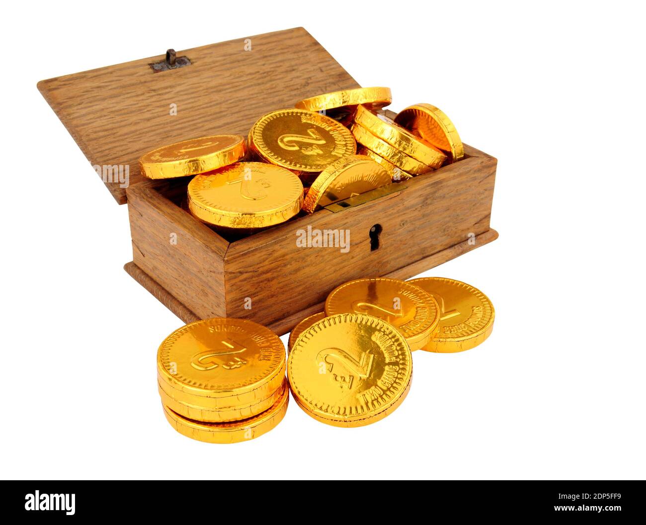 Gold foil covered milk chocolate coins in a small wooden box isolated ...