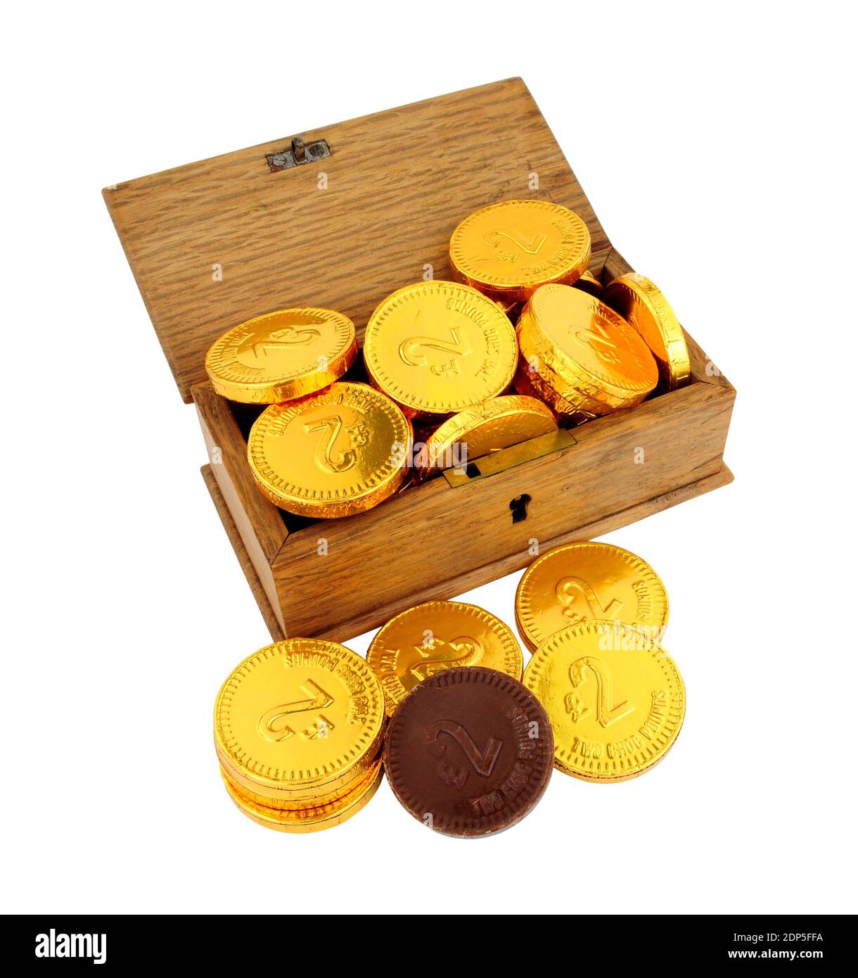 Gold foil covered milk chocolate coins in a small wooden box isolated ...