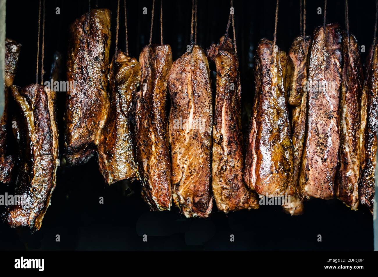 Traditional smoked pork muscles hung on dry Stock Photo - Alamy
