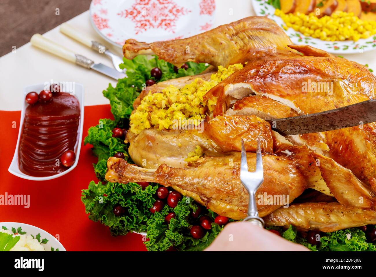 Cutting roasted whole turkey for Christmas dinner. Close up Stock Photo ...