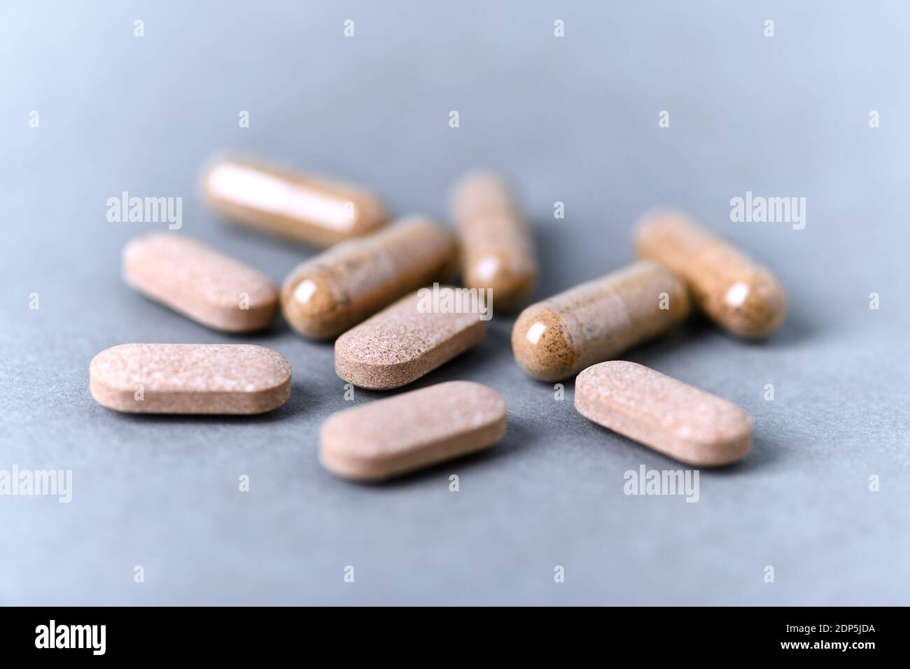 Ashwagandha (Withania somnifera) tablets and capsules on paper ...