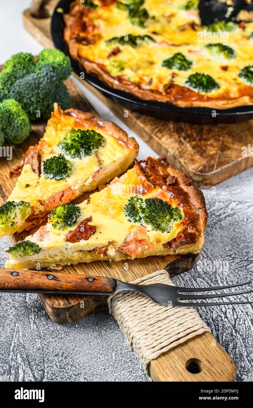 Homemade quiche tart with red fish and broccoli. White background. Top ...