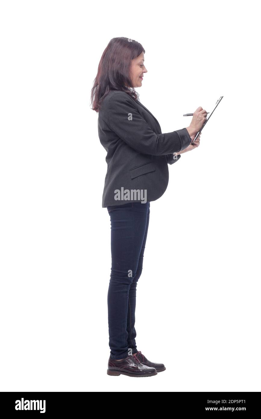 Side view of beautiful brunette businesswoman writing in clipboard ...