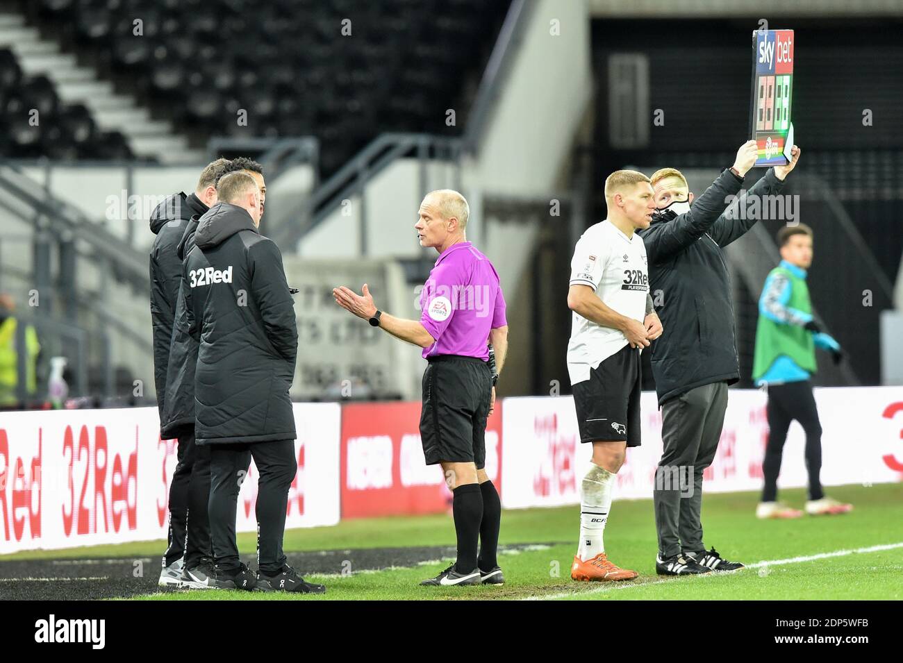 referee Andy Woolmer speaks with Wayne Rooney manager of Derby County ...