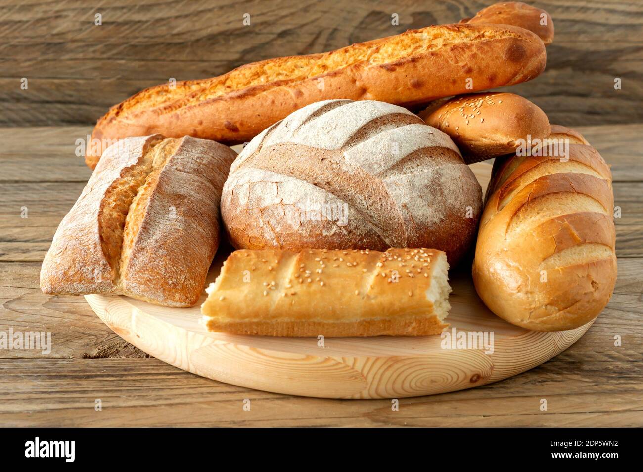 Types of homemade bread on the rustic wooden table. Homemade baked ...