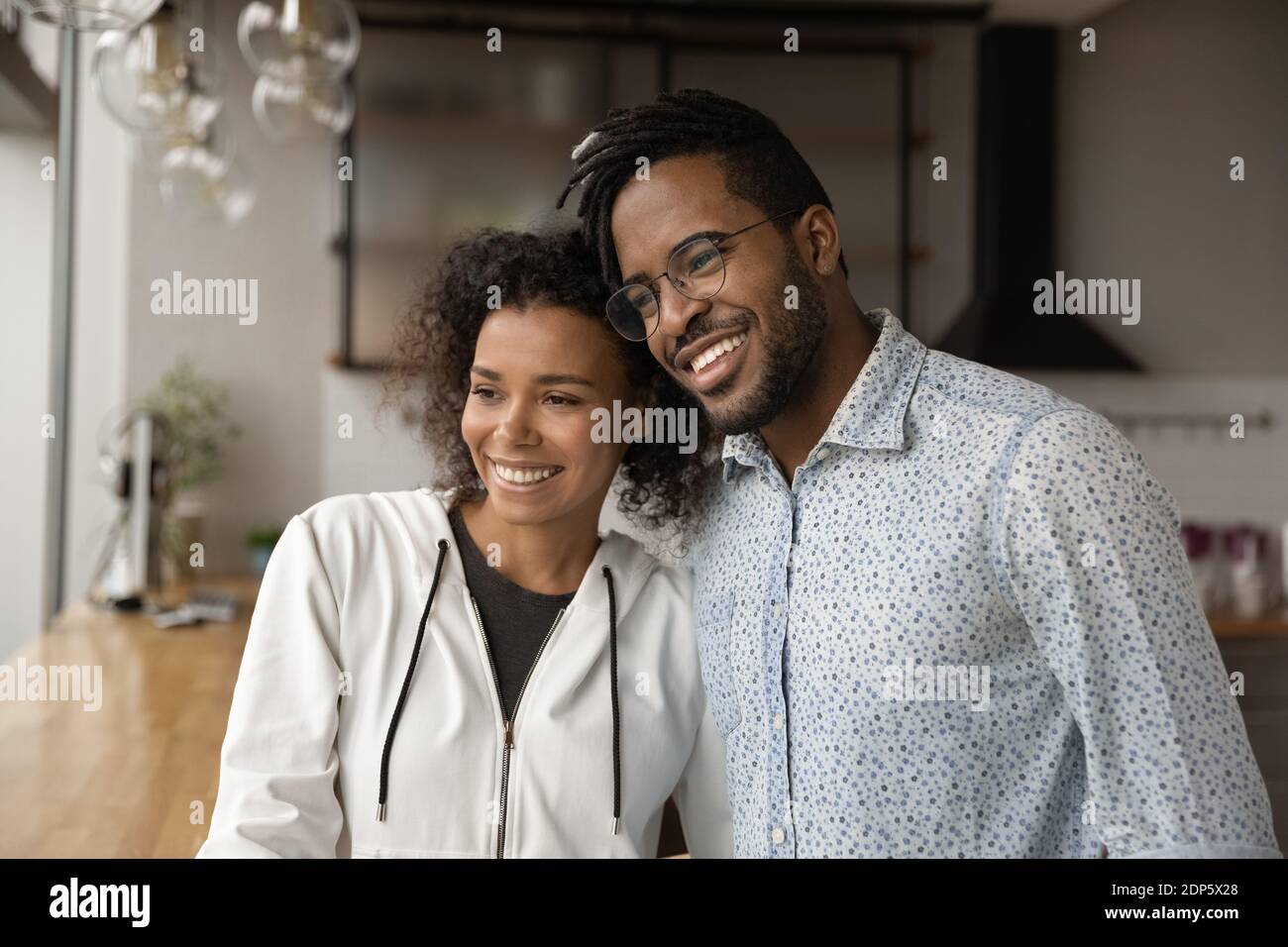 Smiling biracial couple look in distance dreaming Stock Photo - Alamy