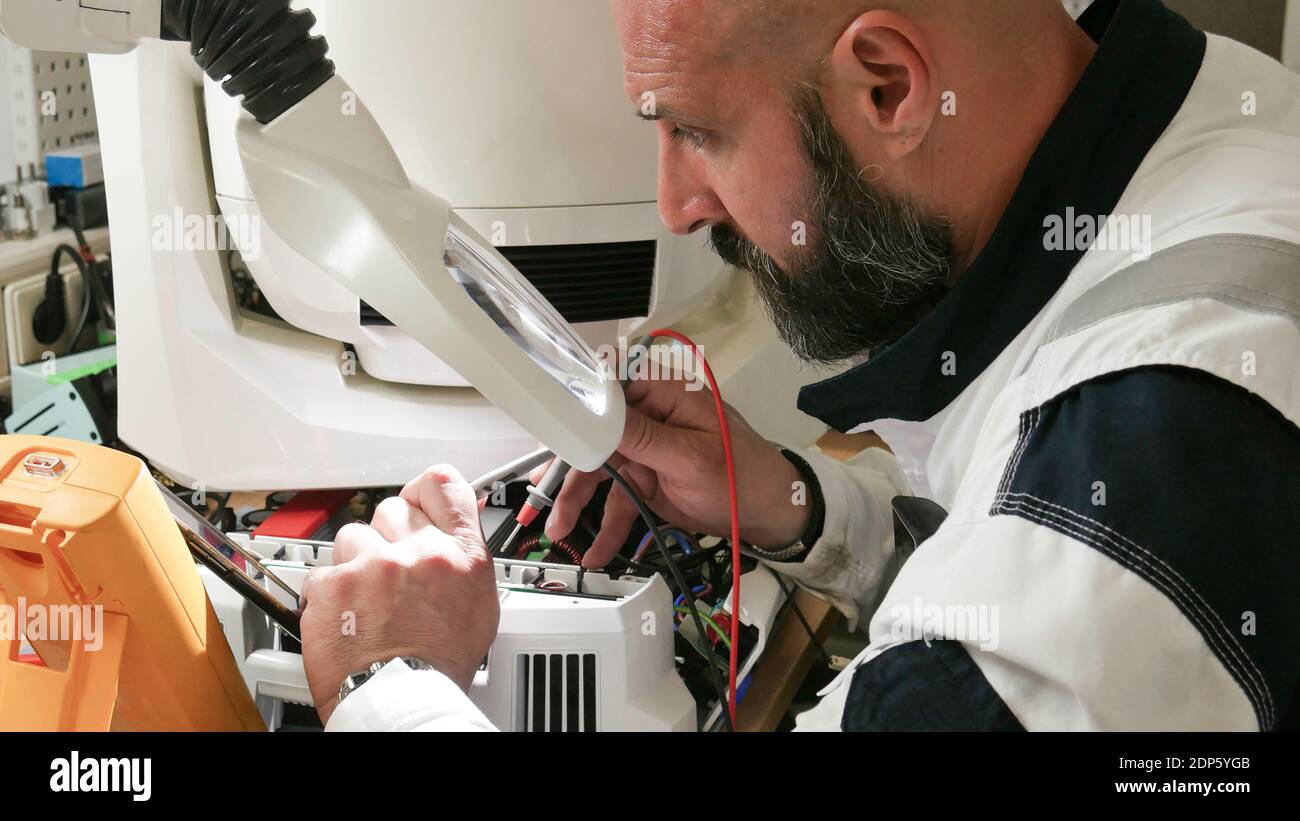 Electronics Maintenance Engineer Soldering Motherboard, Microchip and ...