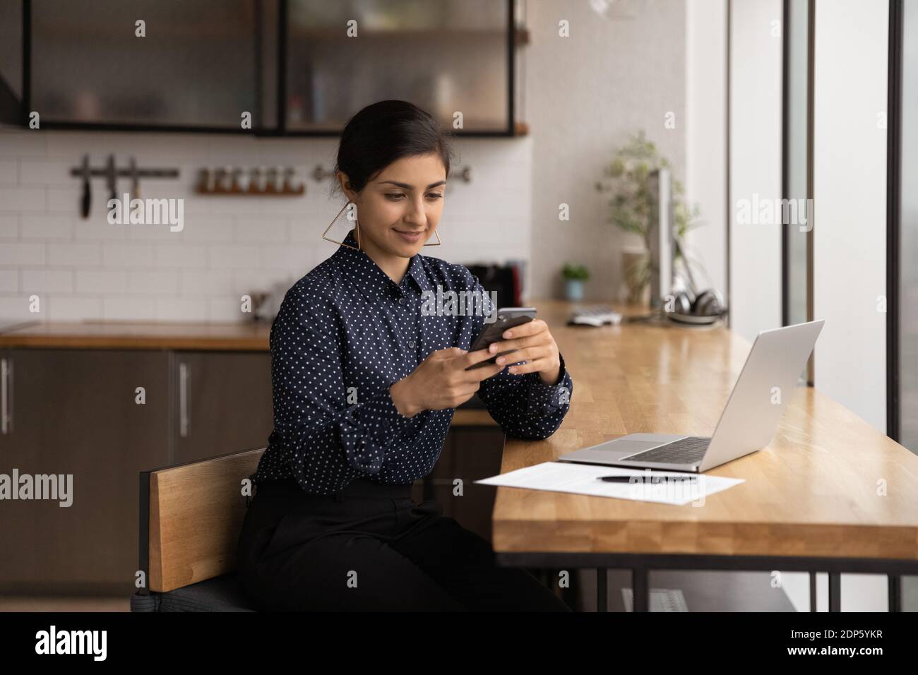 Indian woman use modern smartphone at workplace Stock Photo - Alamy