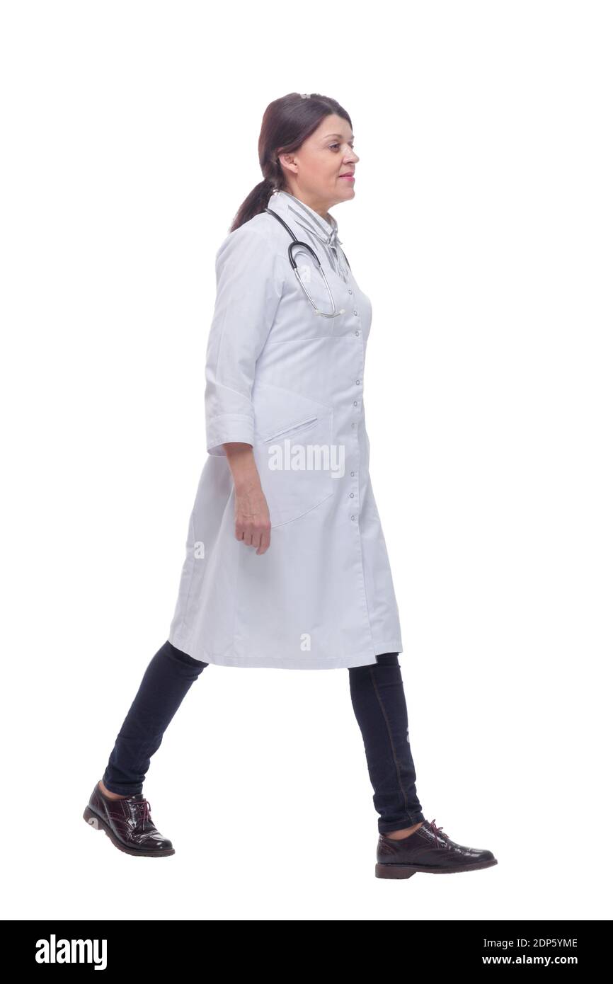 Full length portrait of female doctor walking towards the camera ...