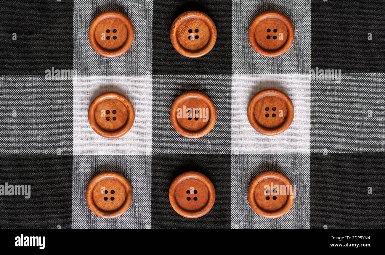 Round wooden brown sewing buttons isolated on textile background. Top ...