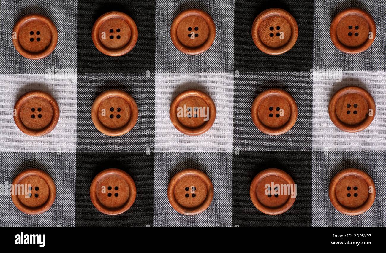 Round wooden brown sewing buttons isolated on textile background. Top ...