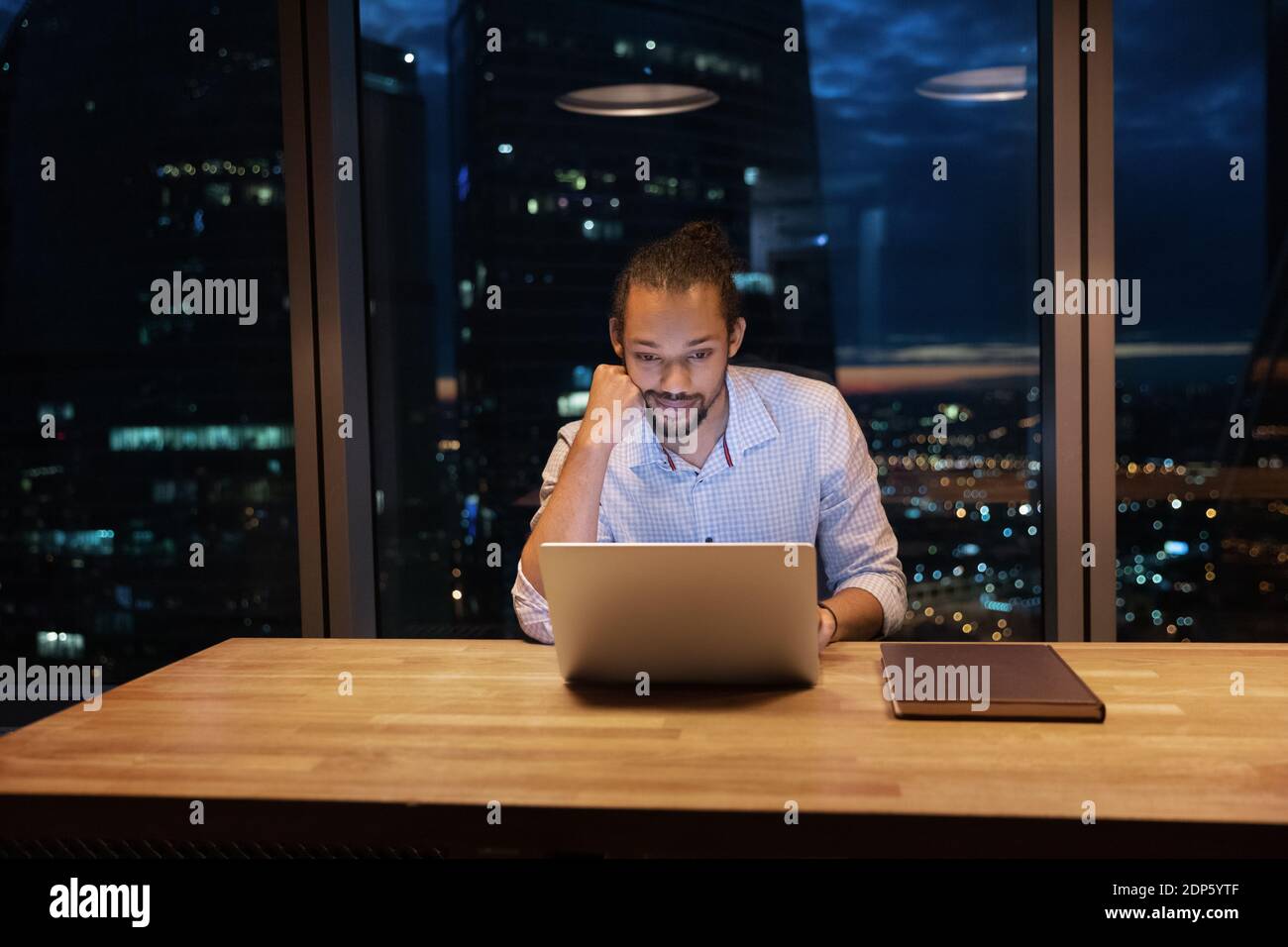African American male employee work in office late hours Stock Photo ...