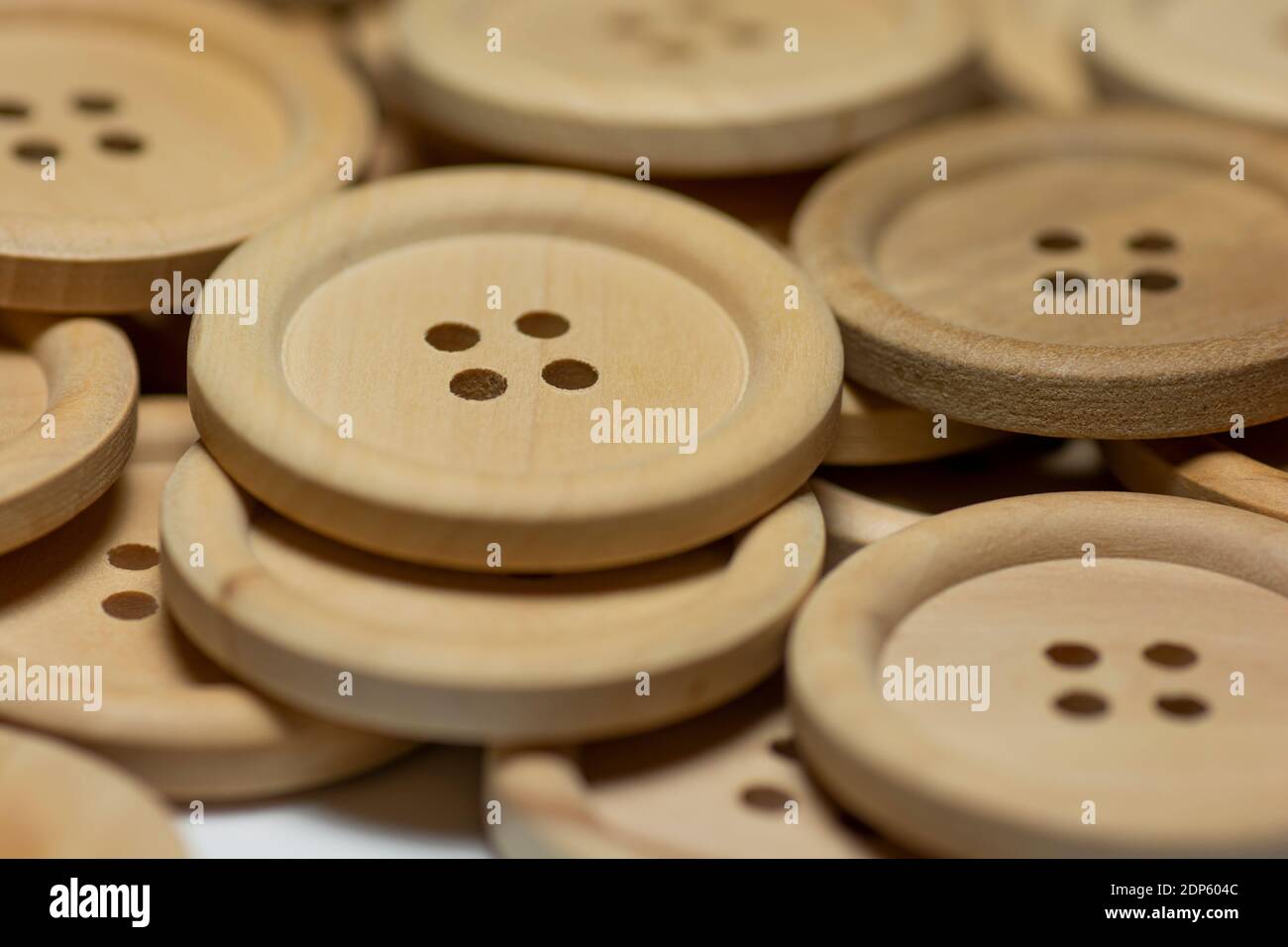 Round wooden sewing buttons isolated on white background. Close up ...