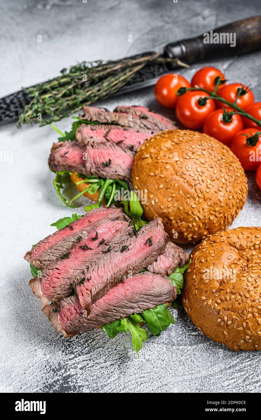 Grilled cold cuts roast beef burger sandwich with arugula and spinach ...