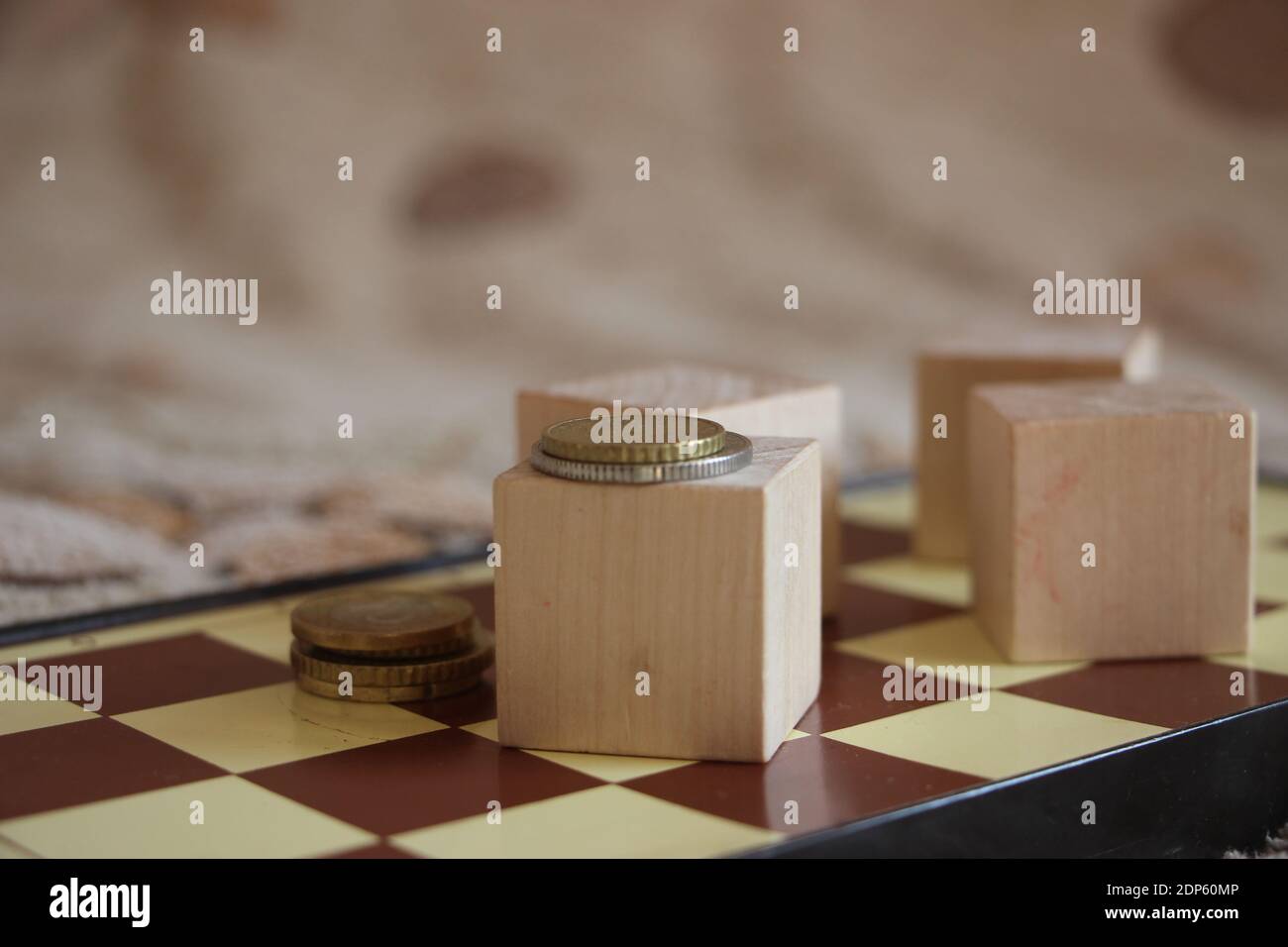 Money coins on chess board and wooden cubes, concept business ...