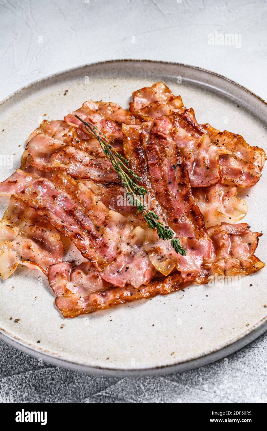 Sizzling hot bacon pieces. Organic meat. Gray background. Top view ...