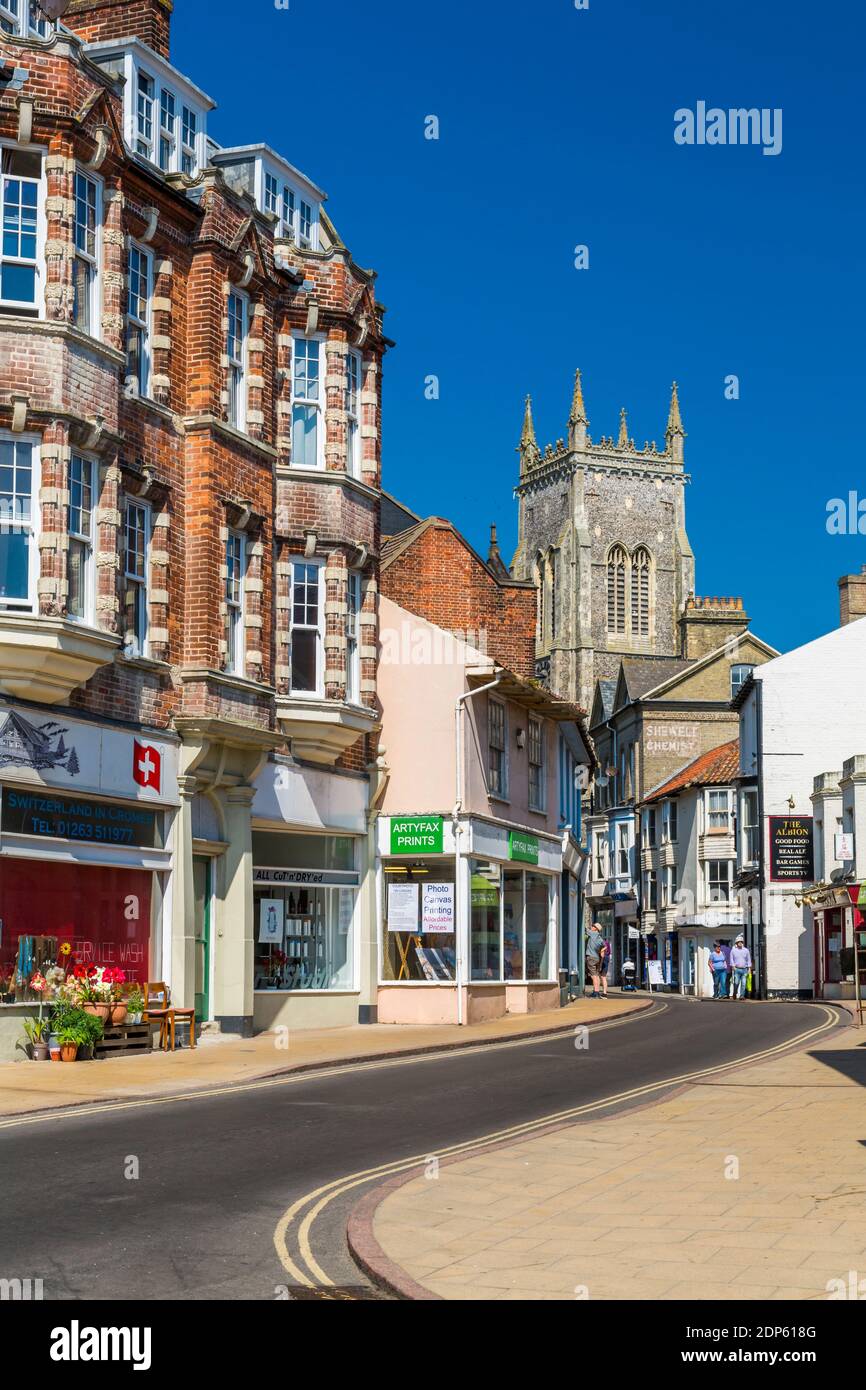 Cromer Parish Church of St Peter and St Paul and colourful houses on a ...