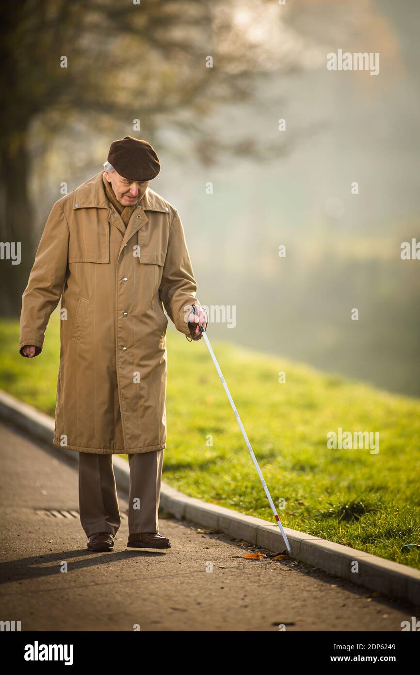 Blind man crossing a street Stock Photo - Alamy