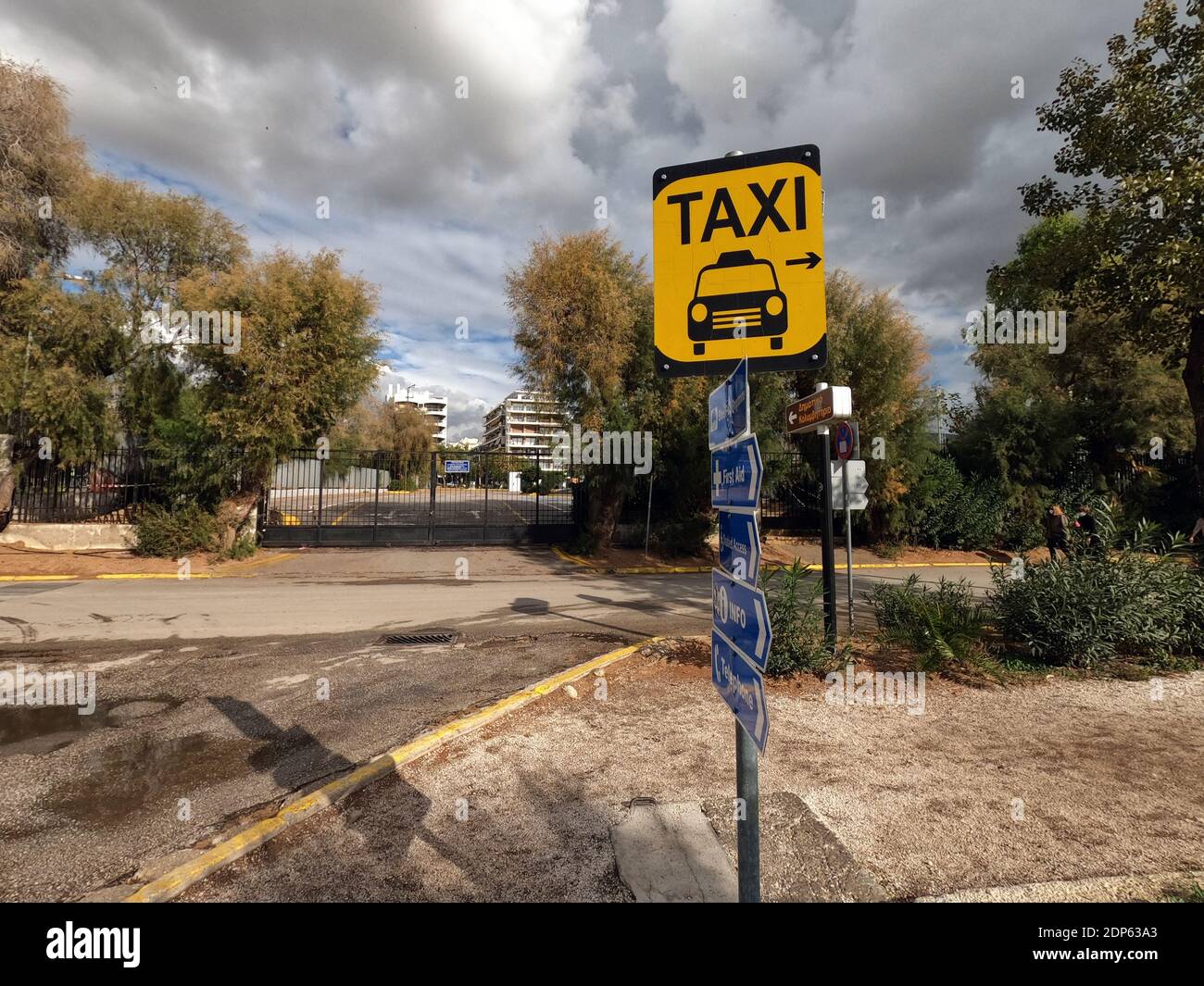 Various signs on the street in yellow, black, white and blue at a ...