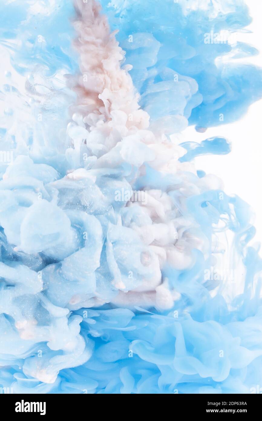 A vertical shot of blue and light pink ink in the water Stock Photo - Alamy
