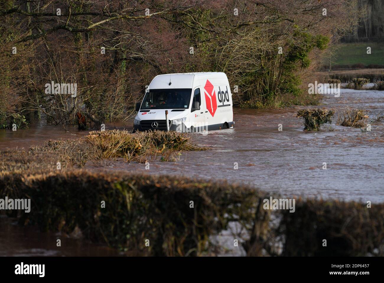 A DPD delivery van stranded in flood water waits for emergency services ...