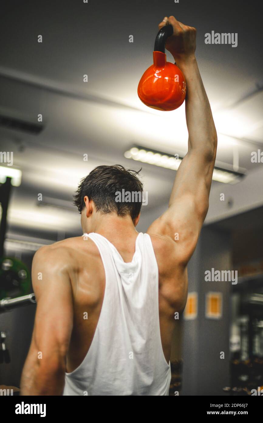A vertical shot of an athlete male exercising in a gym Stock Photo - Alamy
