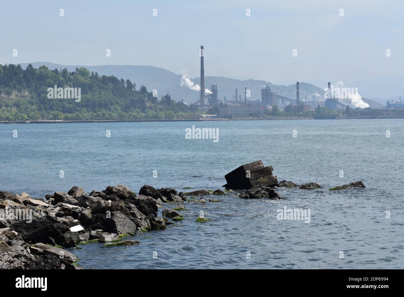 A shot of the clear water on the background of the sea port factory ...