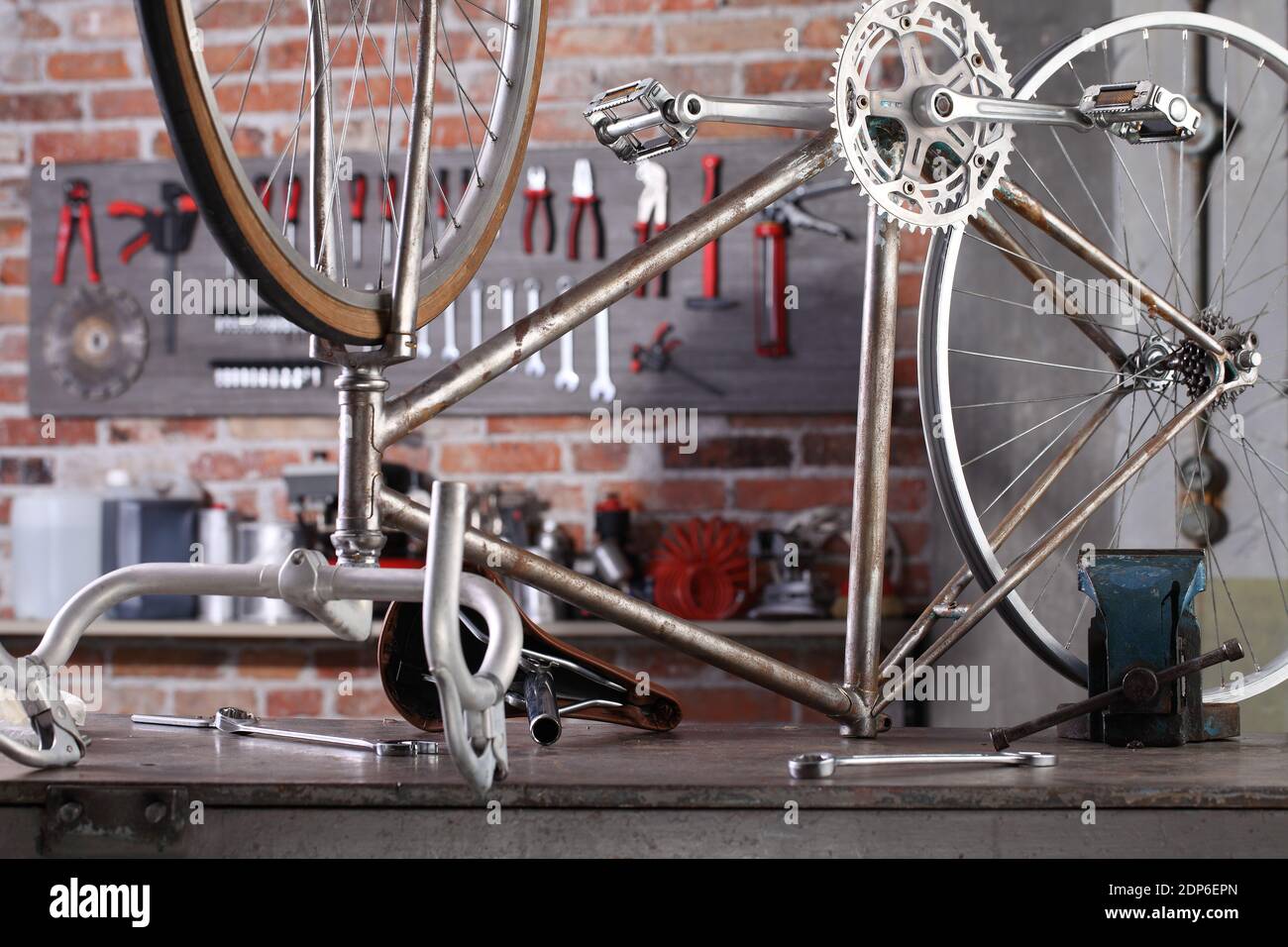 vintage bicycle in garage workshop on the workbench with tools, diy ...