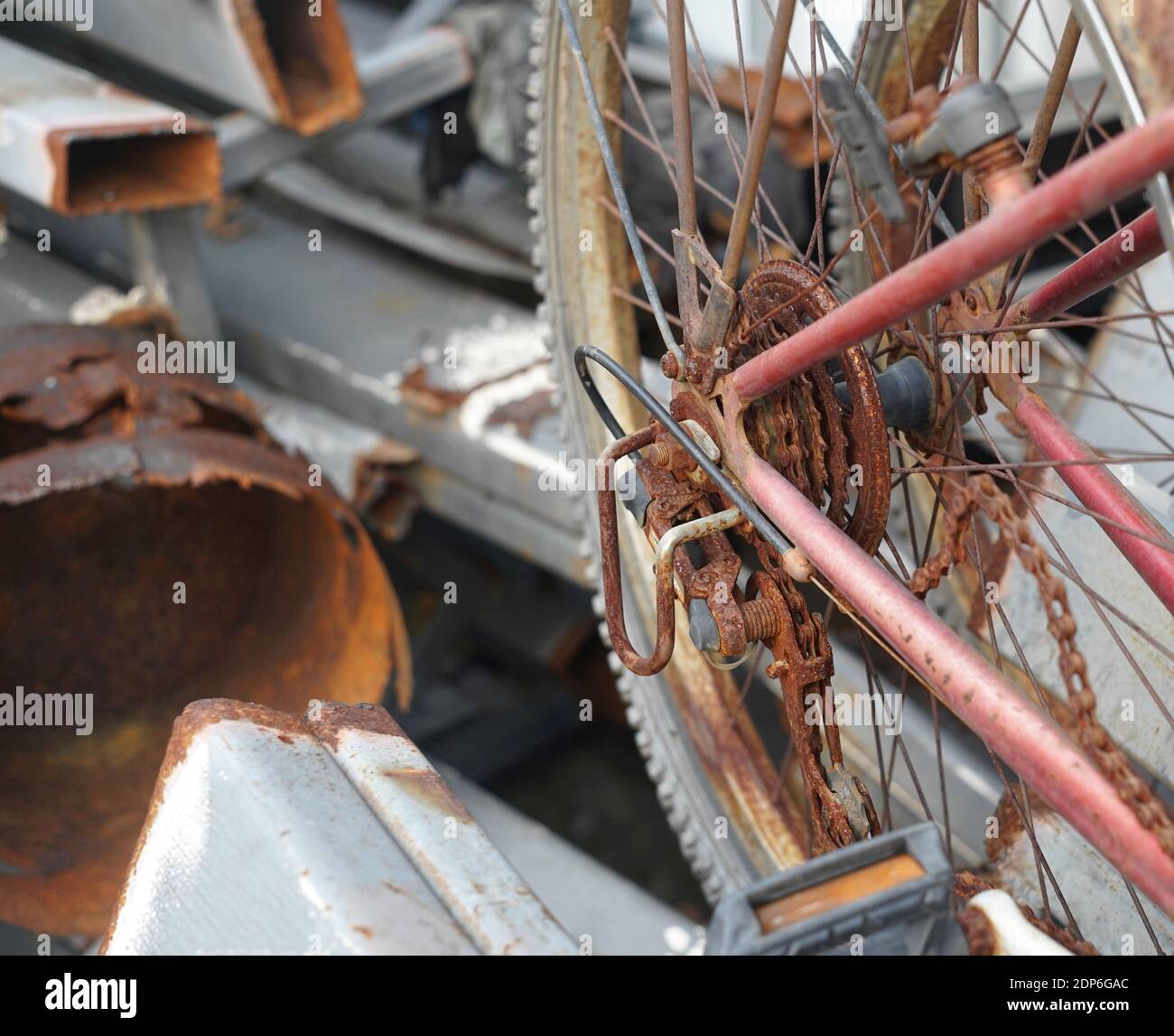 A bicycle very rusts on a steels storage which out of the building ...
