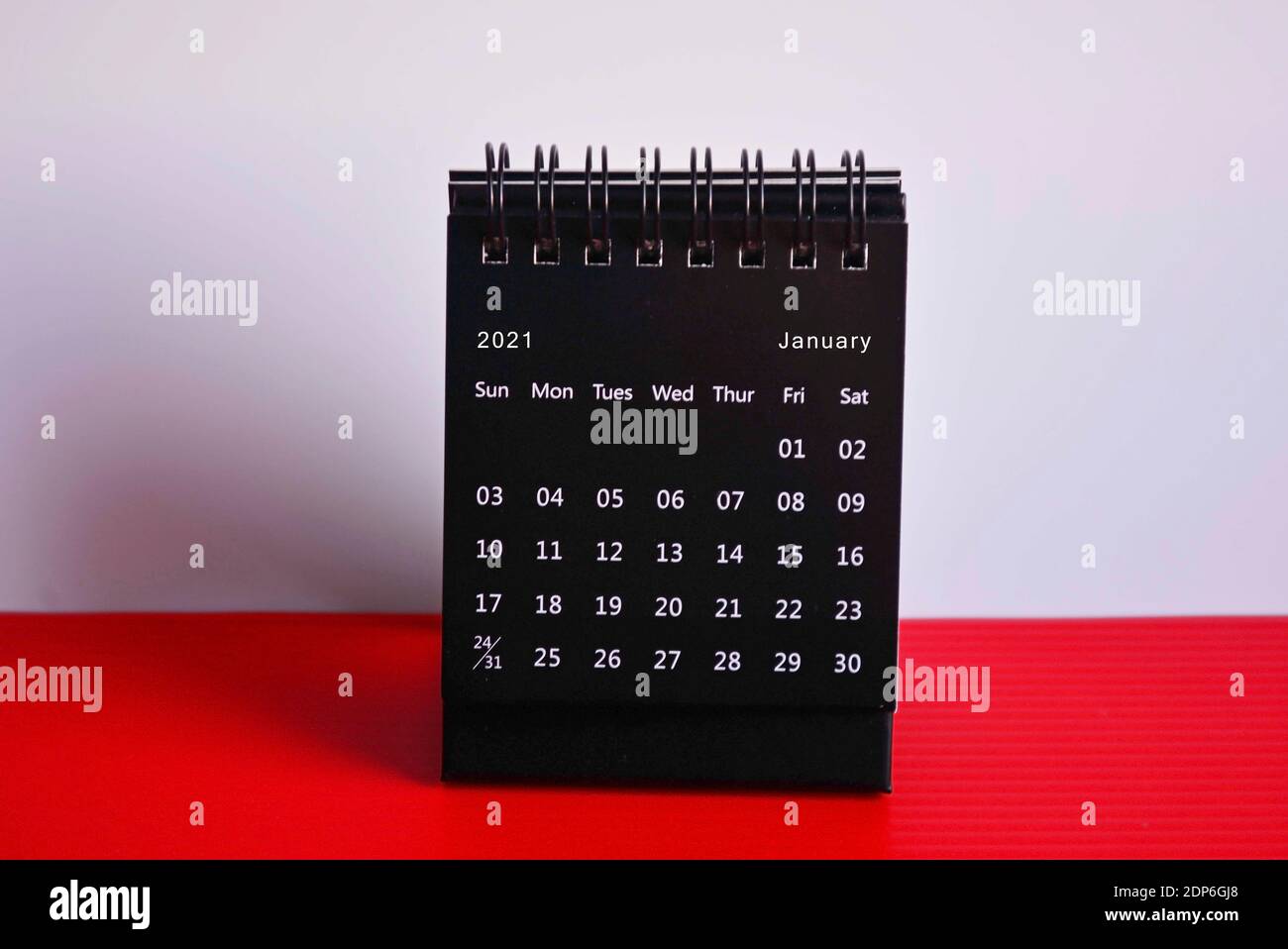 Black January 2021 calendar with white and red backgrounds and potted ...