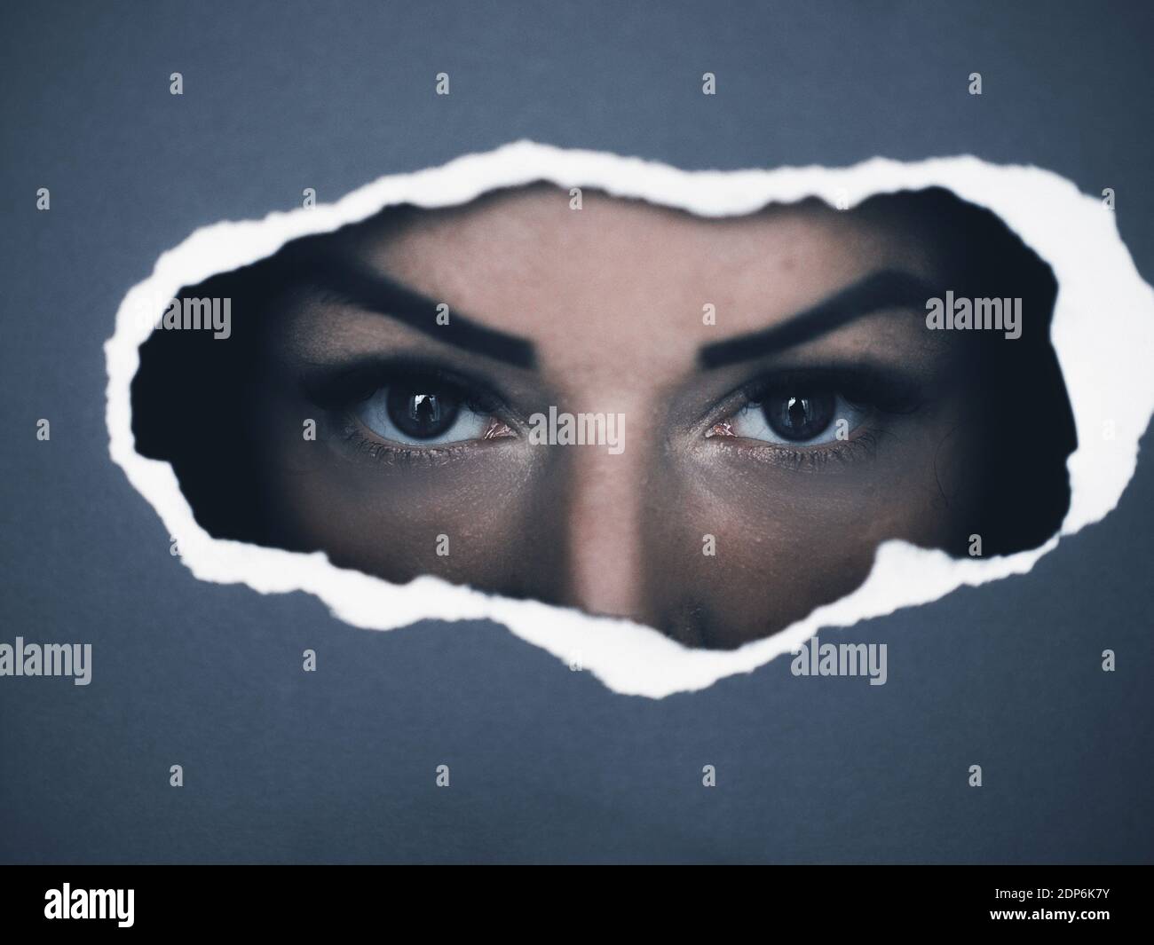 eyes of a beautiful woman and torn paper Stock Photo - Alamy