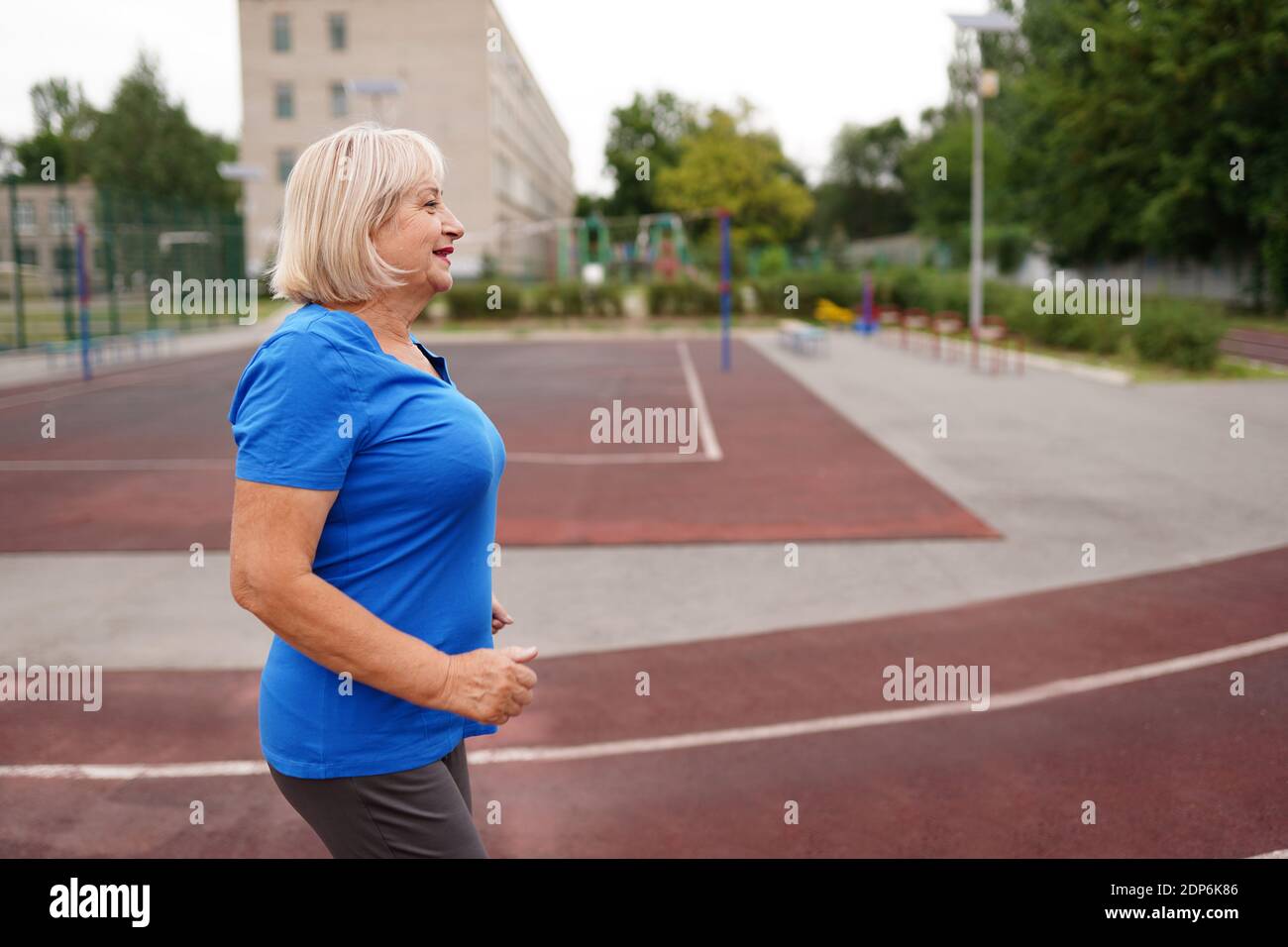 mature woman running in early morning. Attractive looking mature woman ...