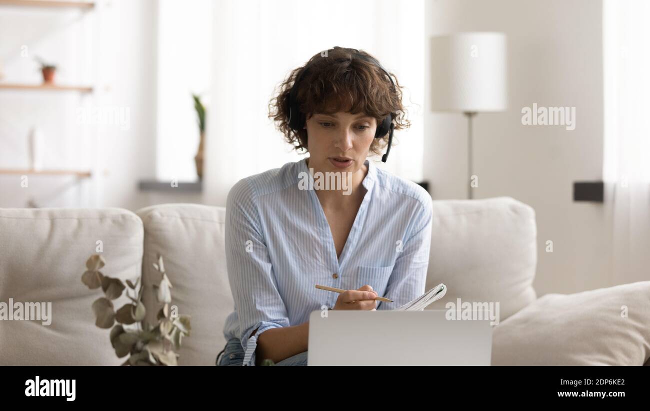 Focused lady in headset learn on distance via video conference Stock ...