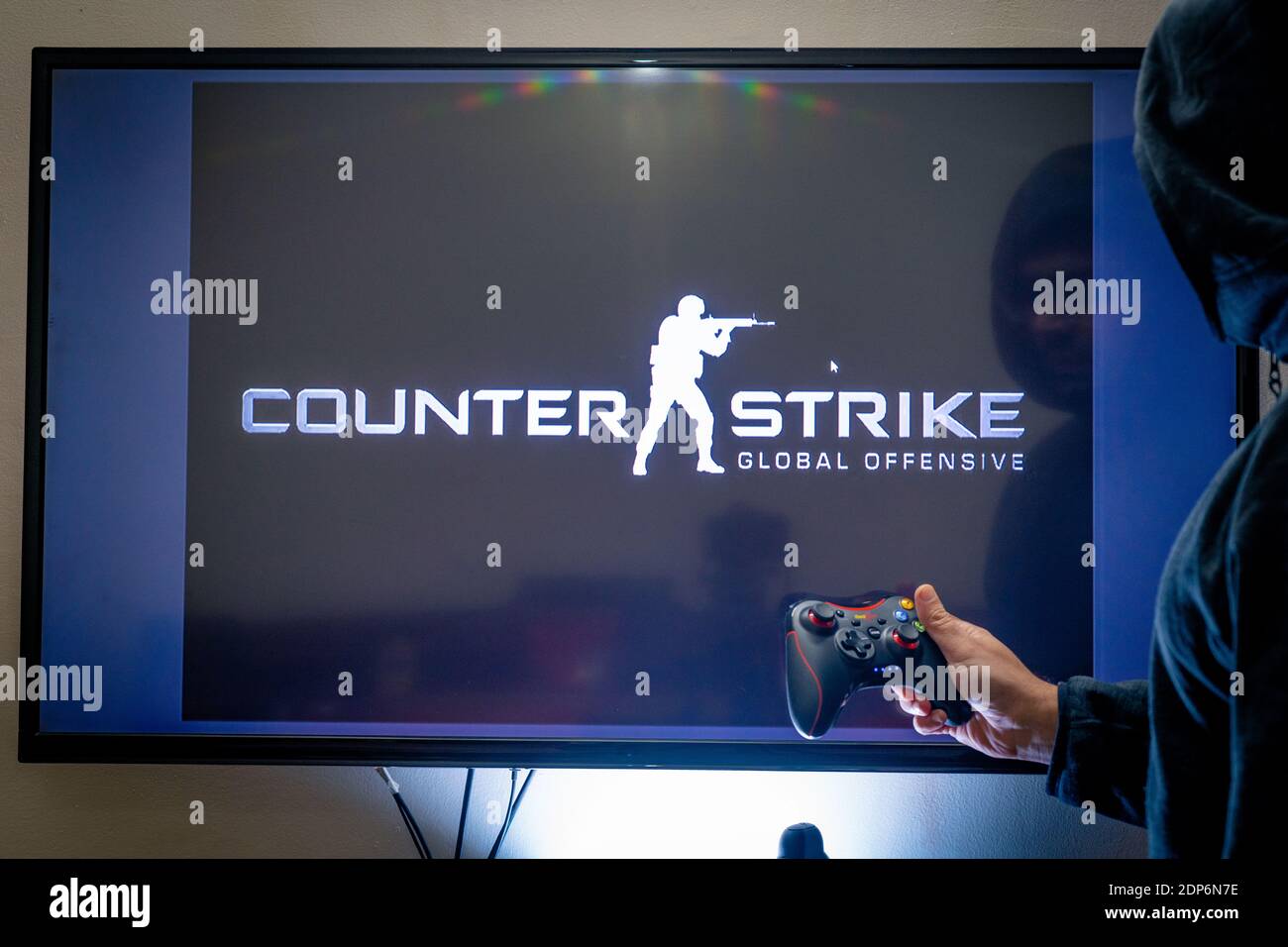 Man holding a steam controller and playing popular video game counter ...