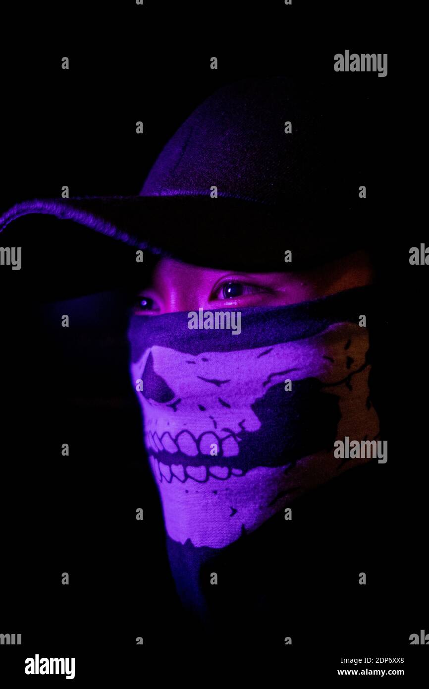 Portrait in the dark of a militant of the pro-democracy movement in ...