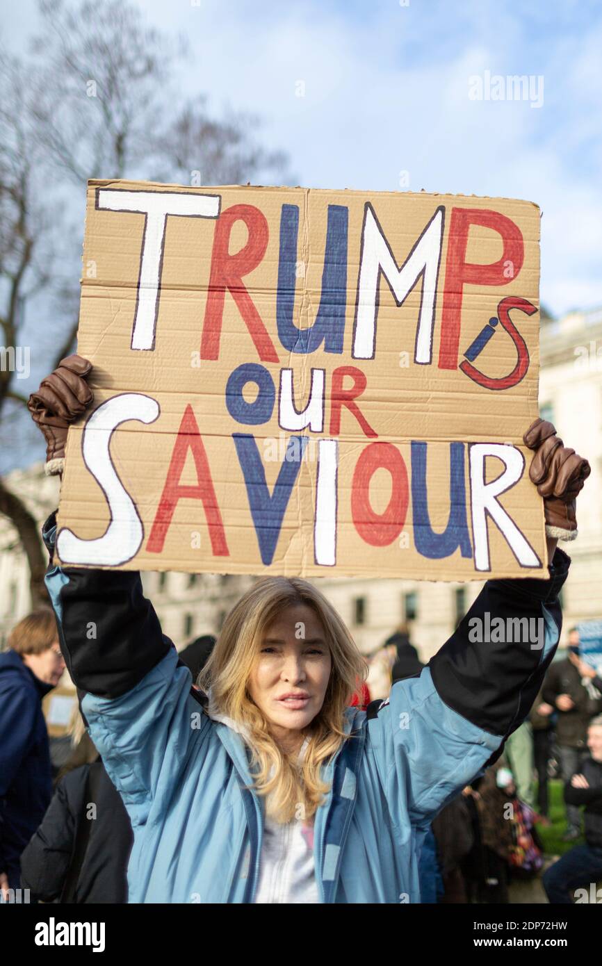 Portrait of a woman holding a 'Trump is our Saviour' placard during ...