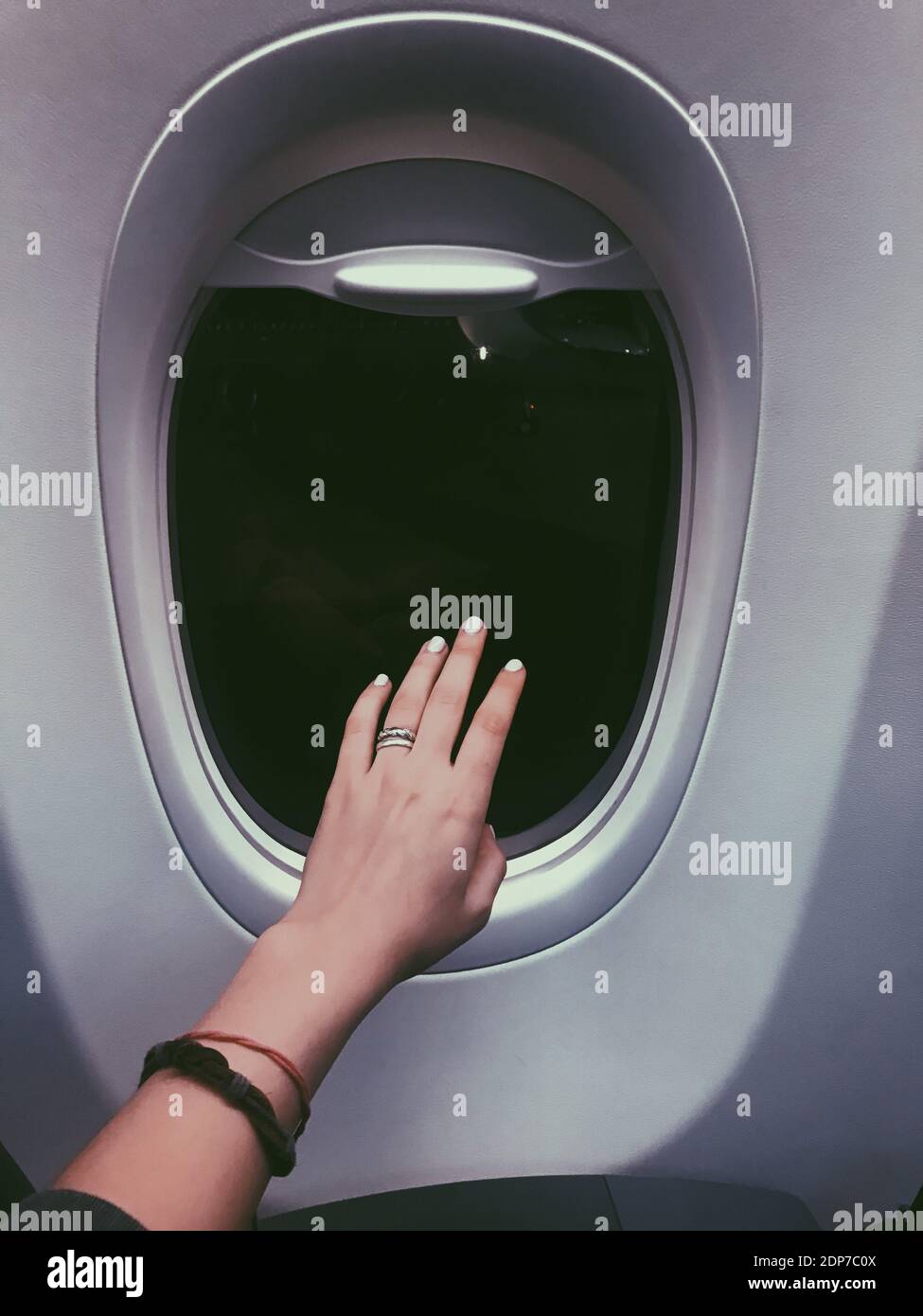 Human hand on airplane window hi-res stock photography and images - Alamy