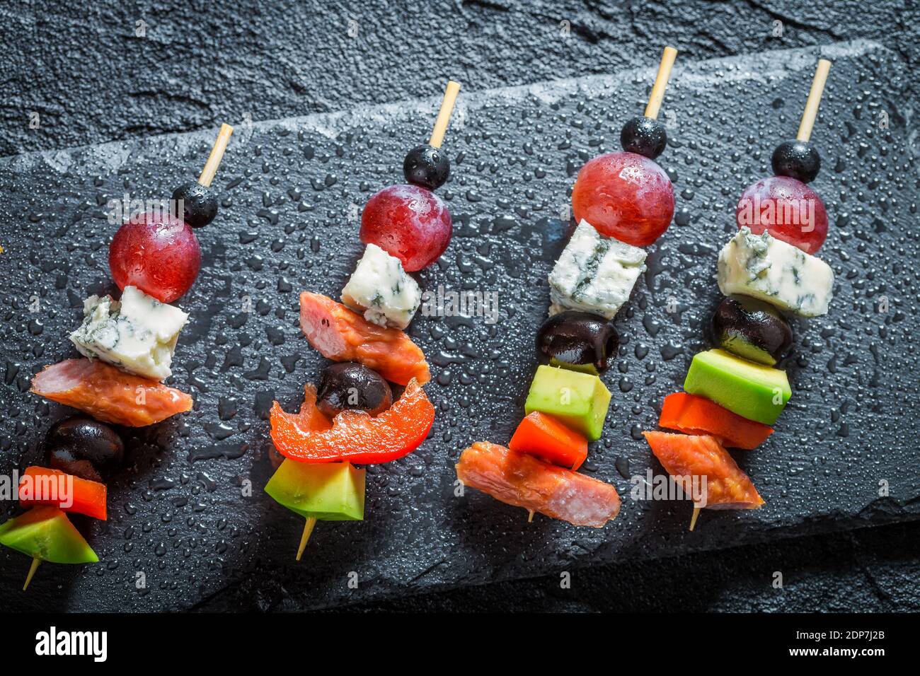 Homemade finger food with fresh ingredients for party on black rock ...