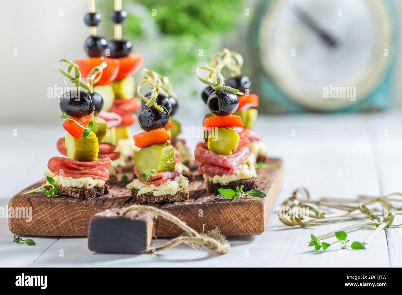 Homemade finger food made of meat, olive and vegetables on white table ...